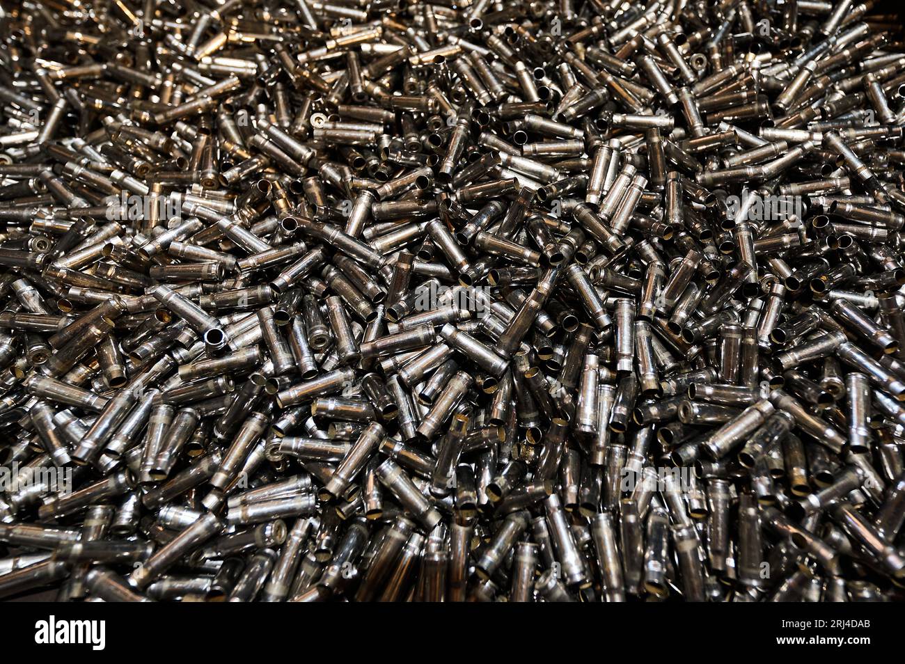 Bullet casings pile in weapon production plant storage Stock Photo - Alamy