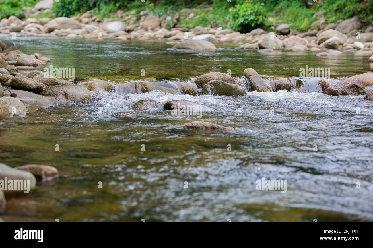 The flow of water in the waterfall stream crashes through the rocks ...