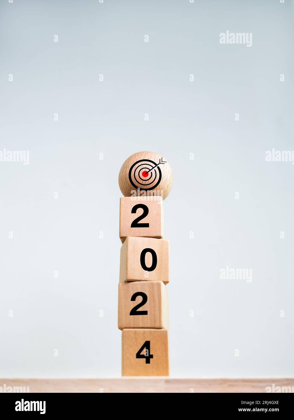 2024 Happy New year background. Target icon on wood sphere on top of ...