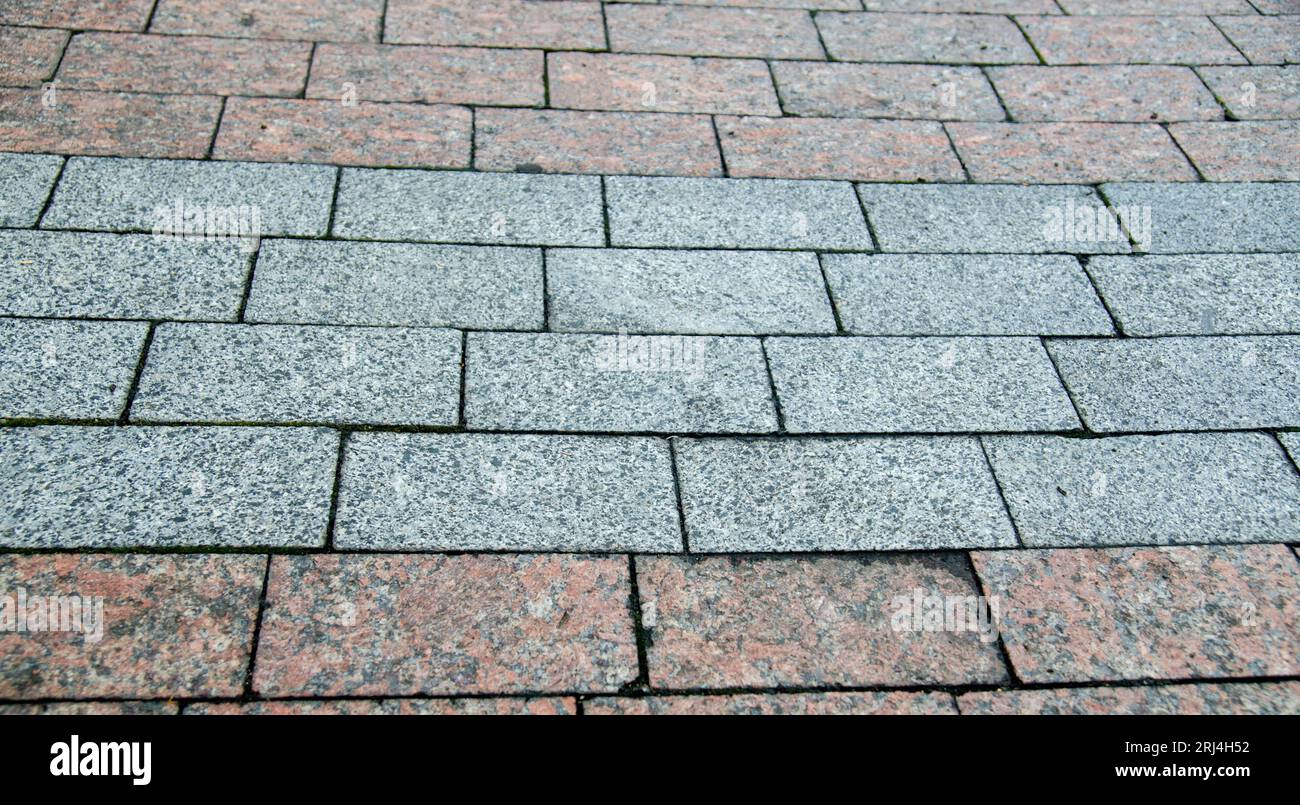 City road pavement made of bricks and stones, road texture in detail ...
