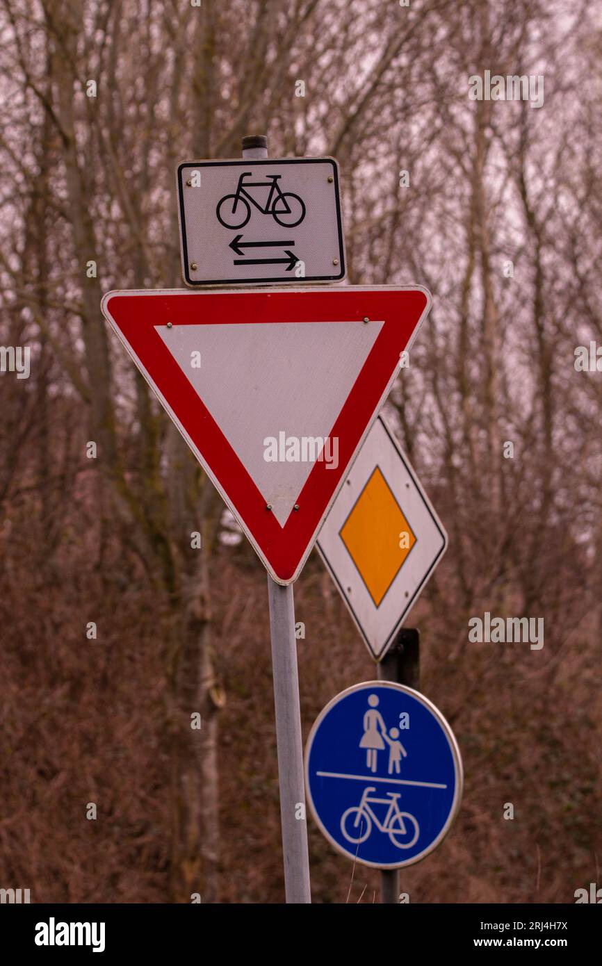 The yield road sign, main road, and bicycles and pedestrians on the ...