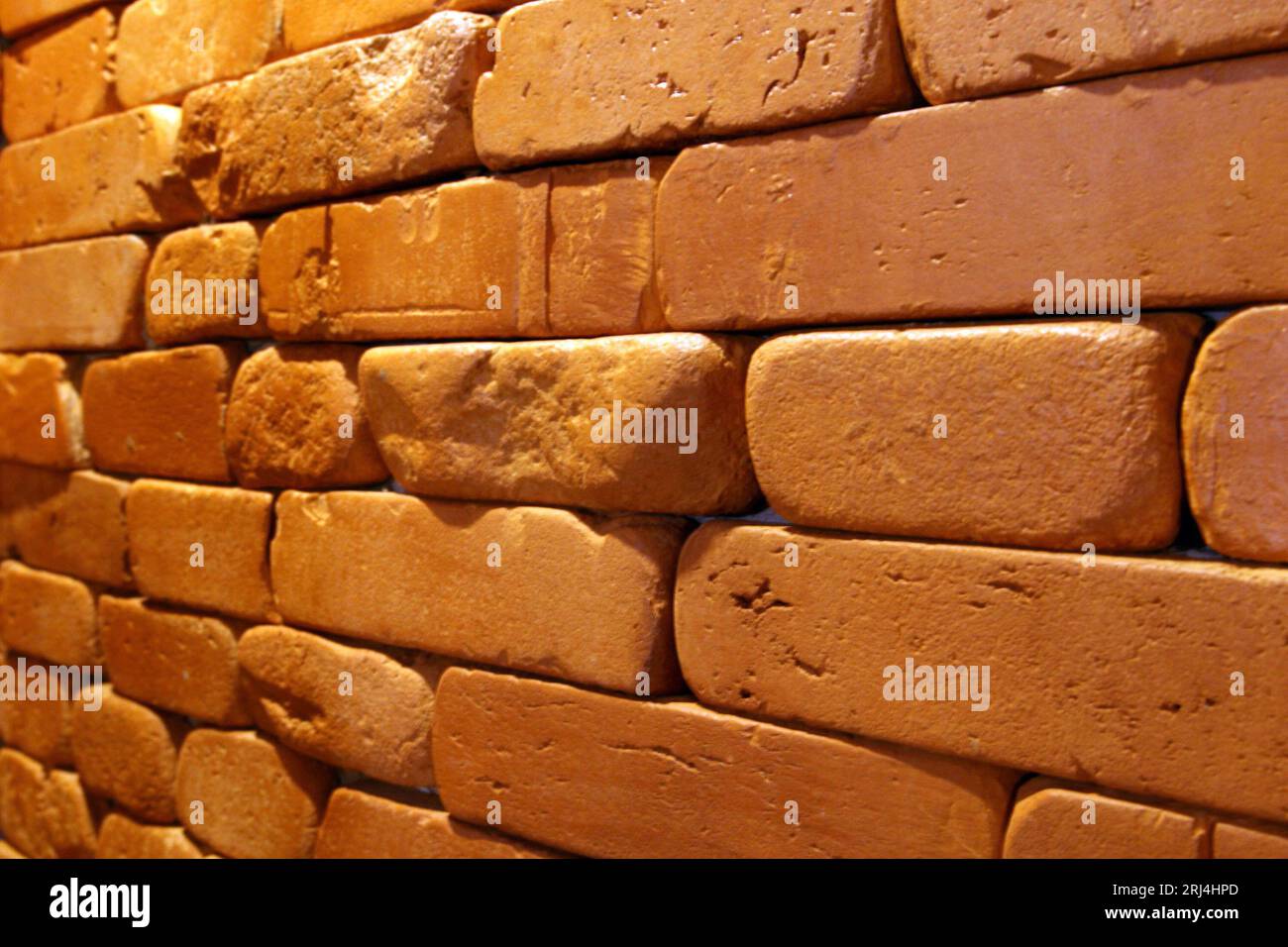 Brick wall texture. Brick pattern made of different orange bricks, warm ...