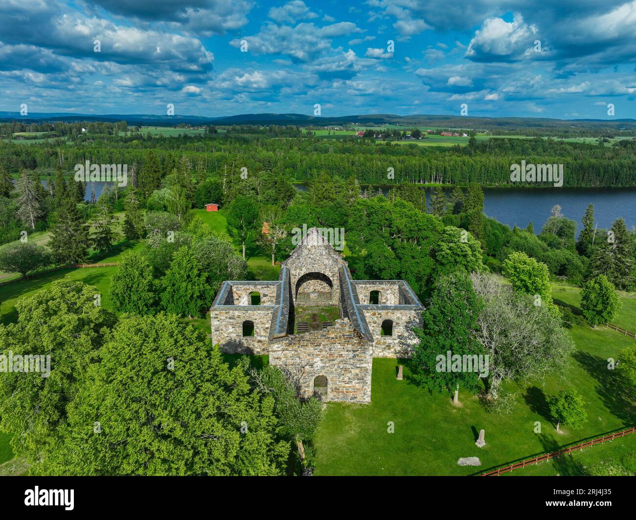 An aerial view of a weathered old building ruins surrounded by lush ...