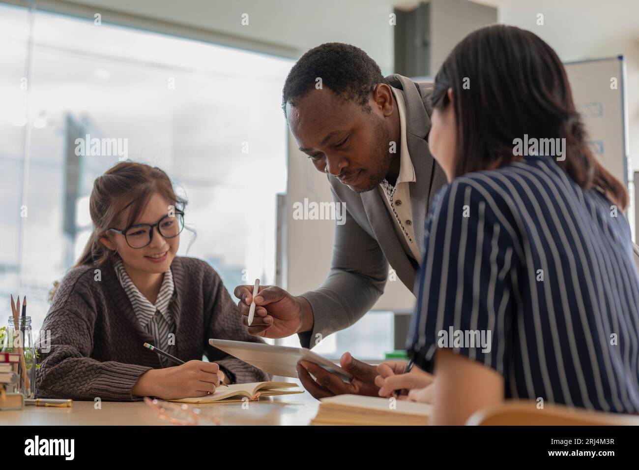 A professional African American businessman or male boss training Asian ...