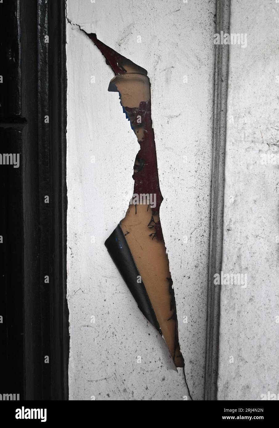 rip in wall by front door Stock Photo - Alamy
