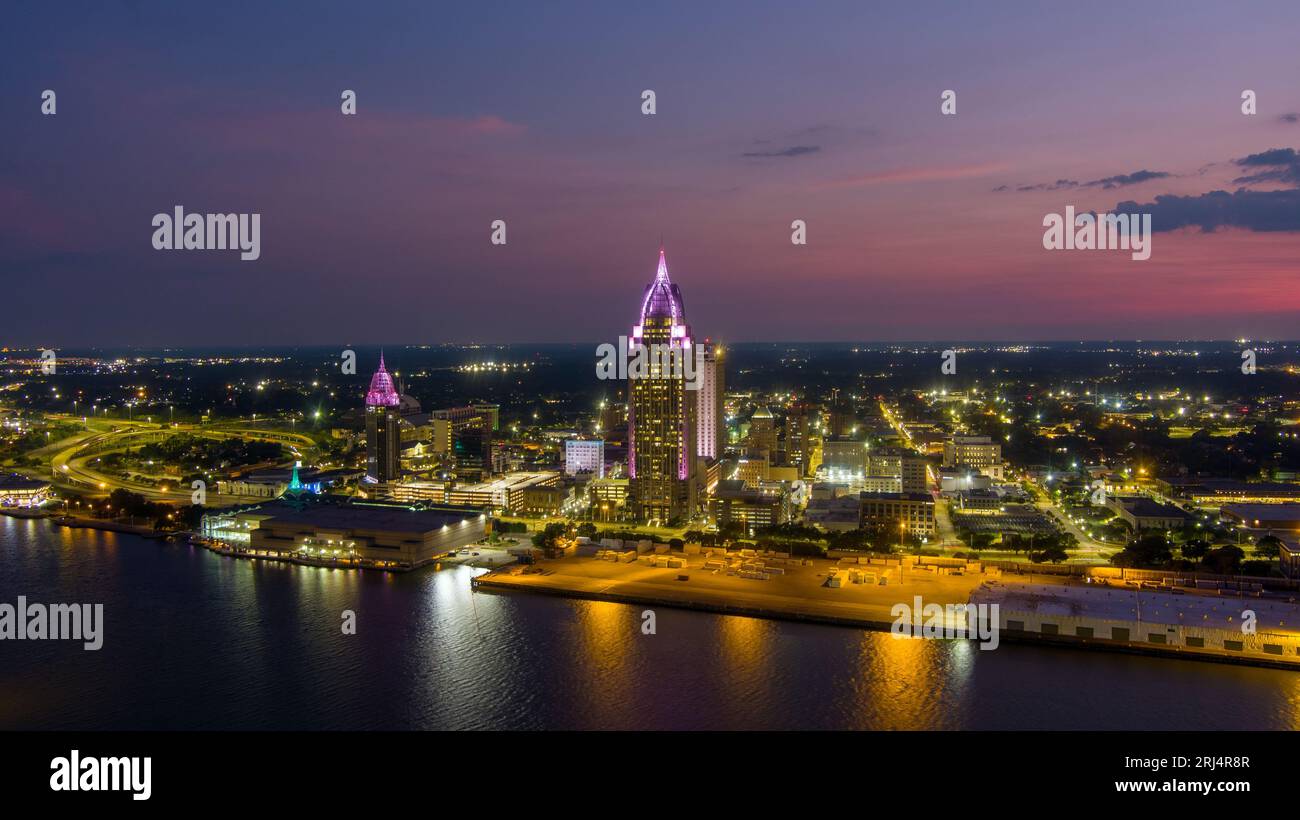 Waterfront city skyline at sunset Stock Photo - Alamy