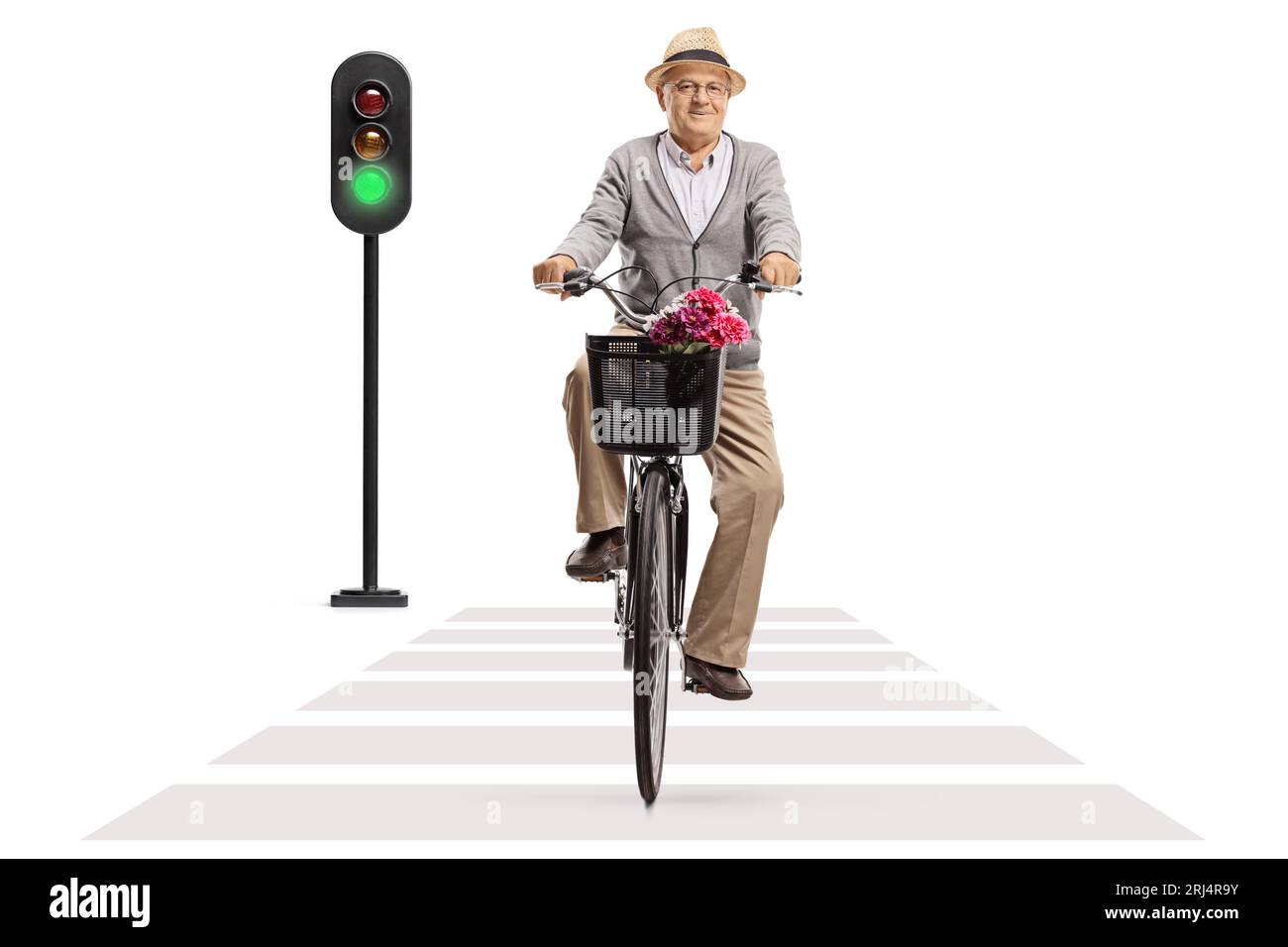 Elderly man riding a bicycle at a pedestrian crossing isolated on white ...