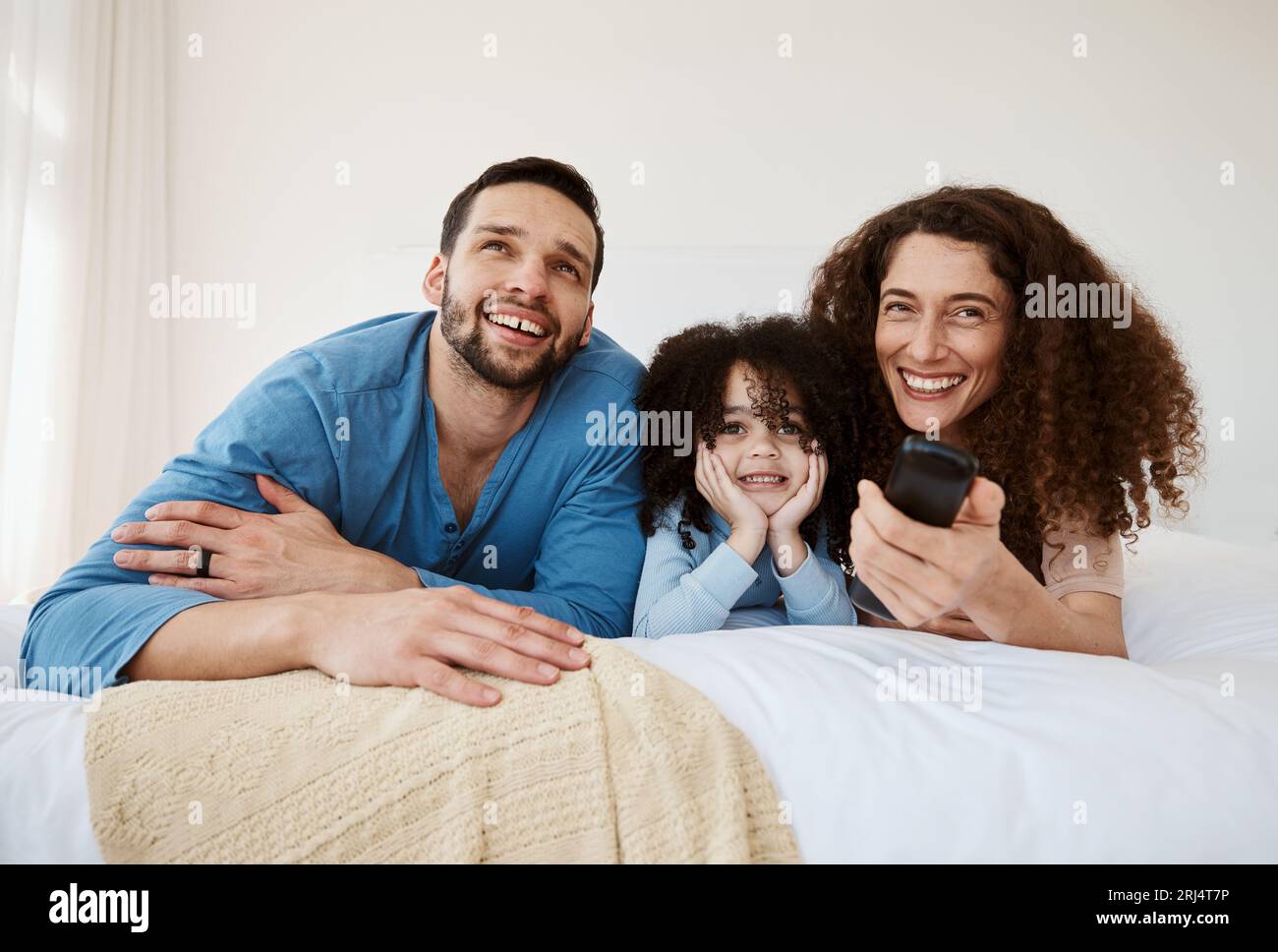 Bedroom, happy family child and parents watching tv series, movie or ...