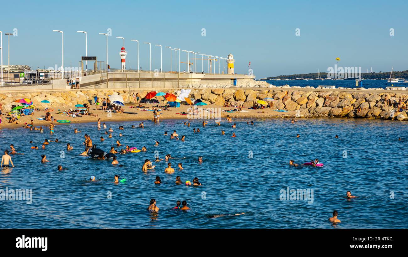 Cannes, France - July 31, 2022: Tourists sunbathing on Plage du Midi ...