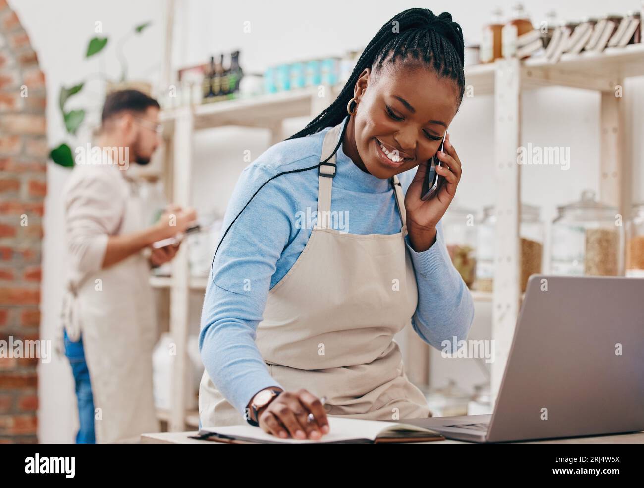 Black woman, cashier and phone call with networking and inventory check ...
