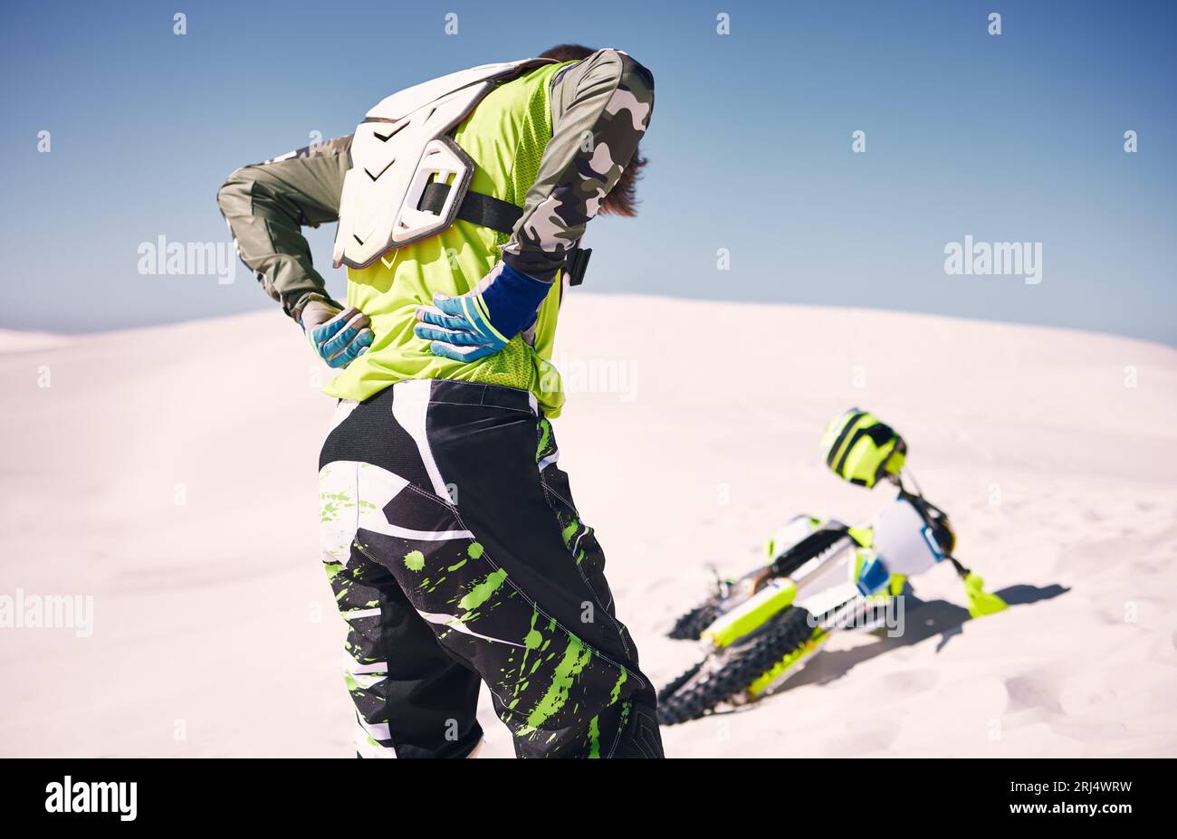 Motorcycle, accident and back pain of man with motorbike, sports and ...