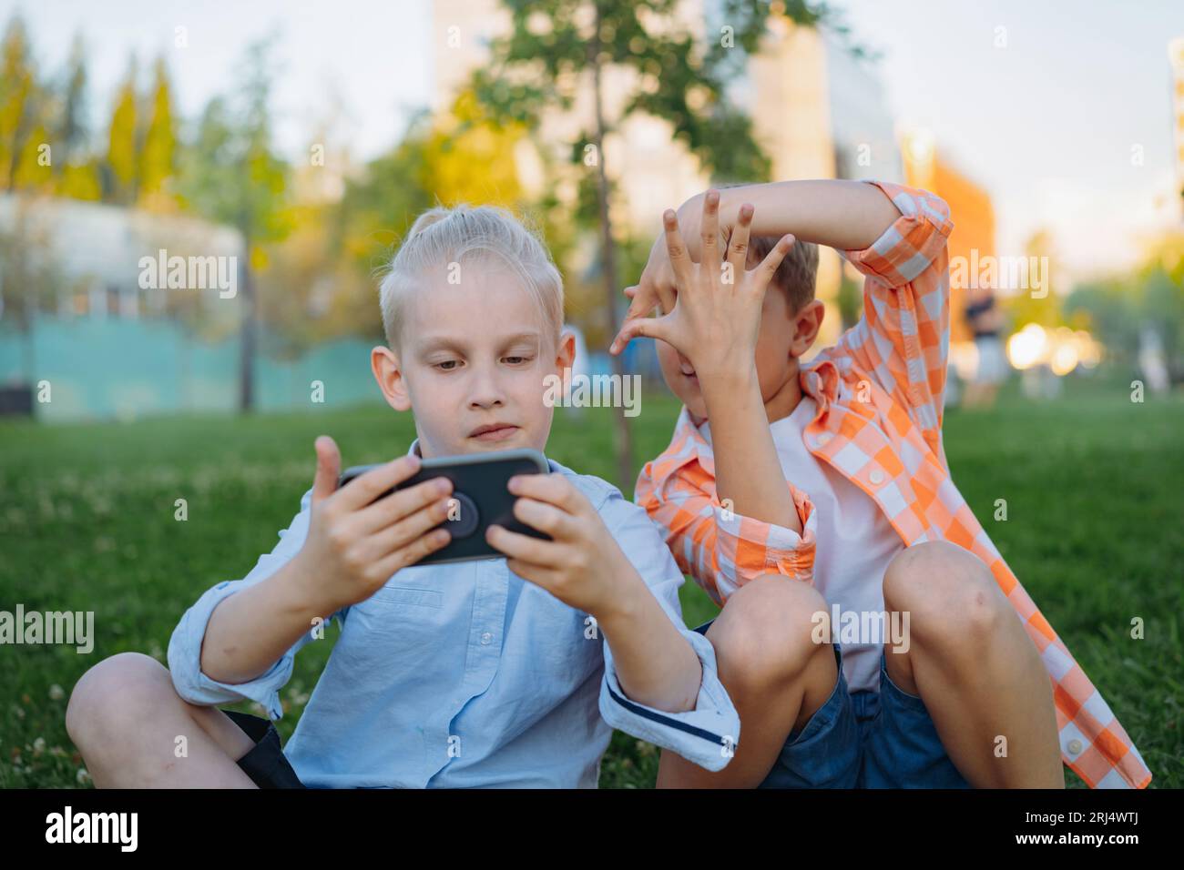 cute funny children shooting selfie with smartphone making frame of ...