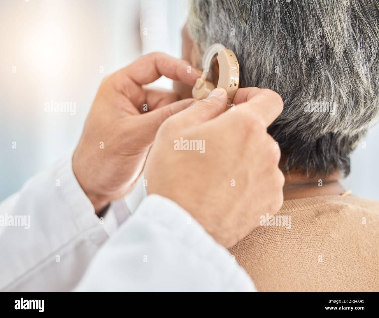 Hearing aid, senior patient and doctor hand with consultation and ...