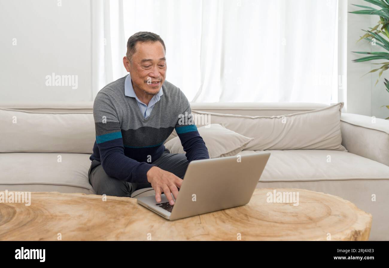 Home office scenario capturing senior man comfortably sitting on a ...