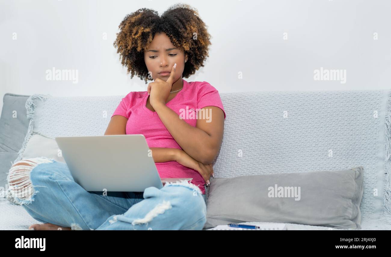 African american young adult with concentration at computer indoors at ...