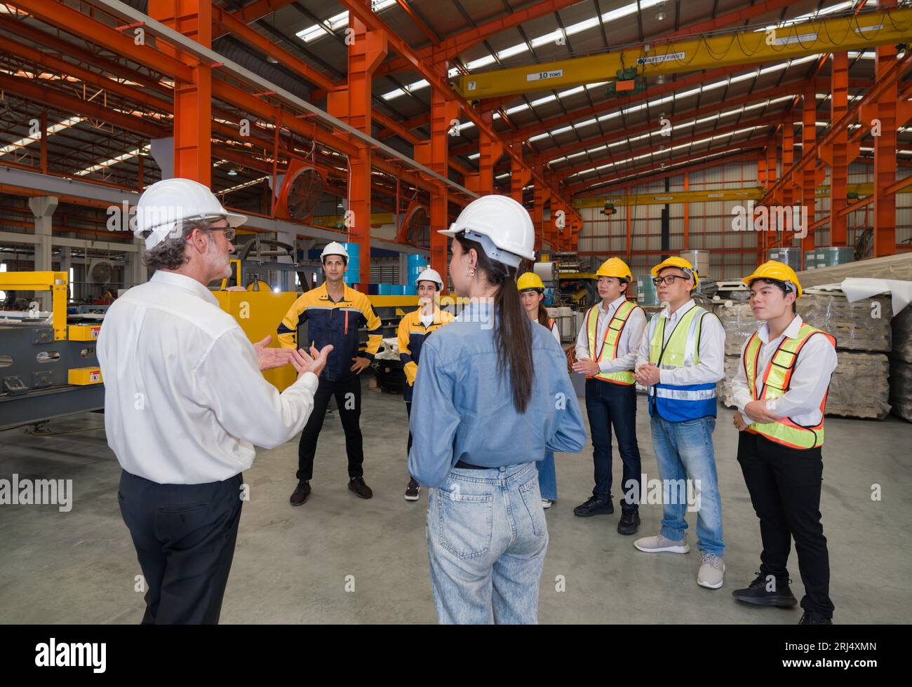 Warehouse safety meeting, people with hard hats. Industrial teamwork ...
