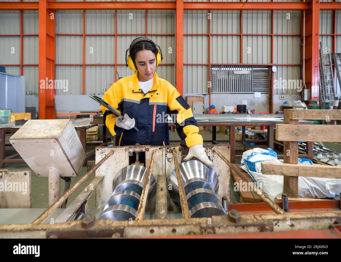 Industrial environment with focus on a diligent worker, engrossed in ...