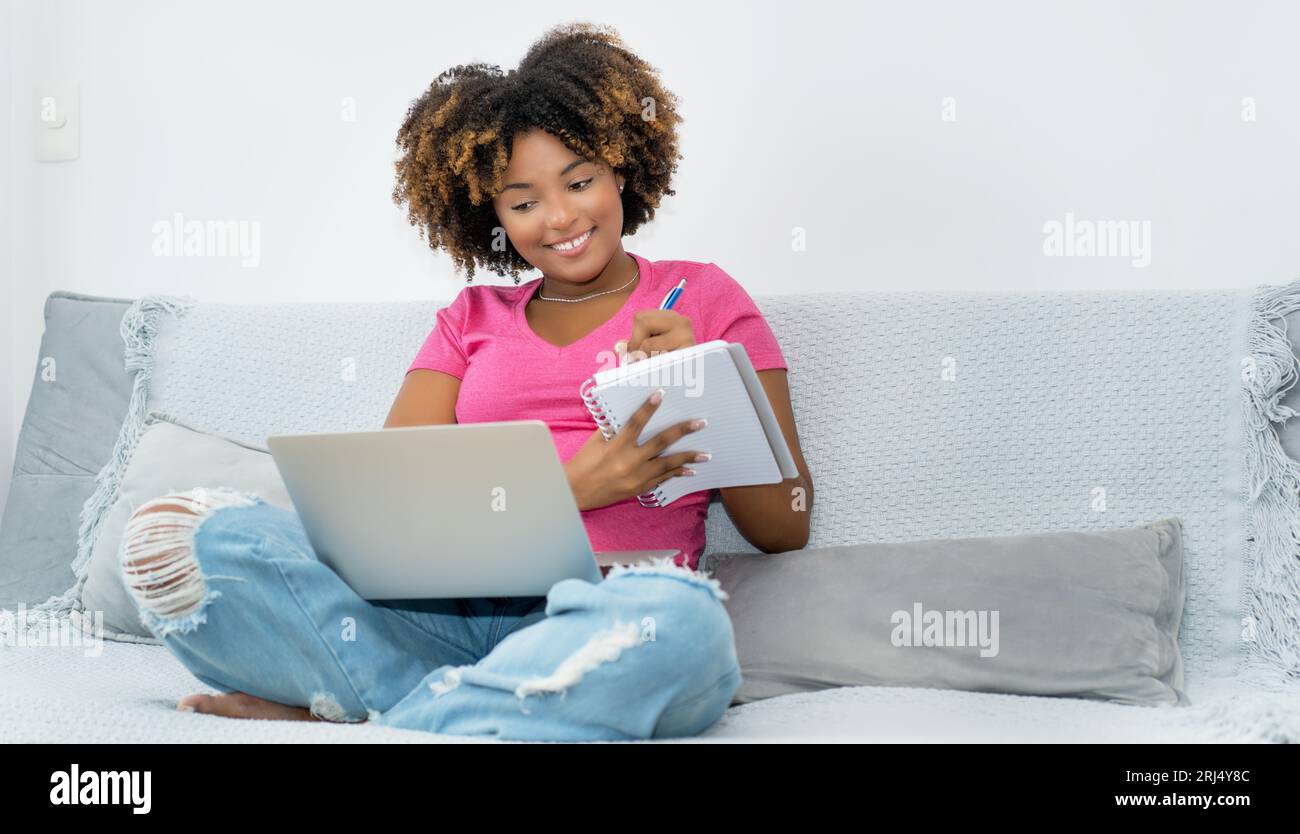 Learning african american female student at computer indoors at home ...