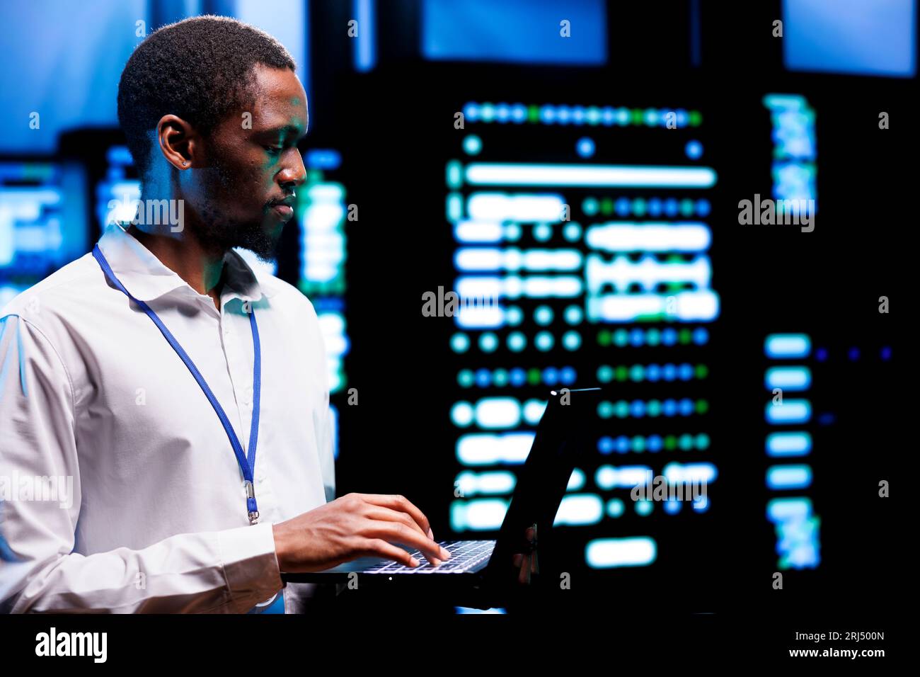 Precise engineer inspecting blade servers performing data backups and ...