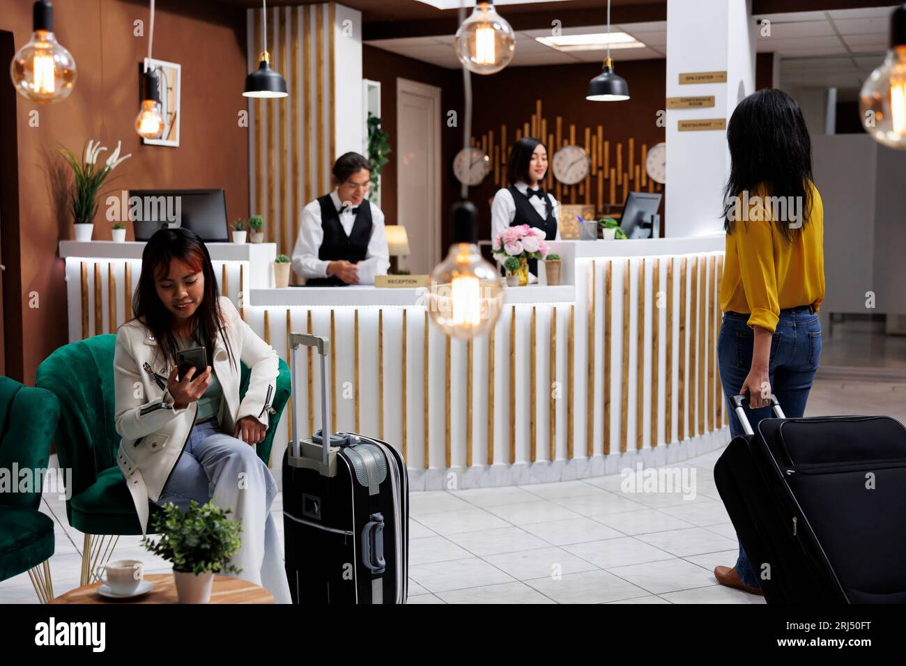 Guests arrive on vacation and are standing at cozy hotel entrance with ...