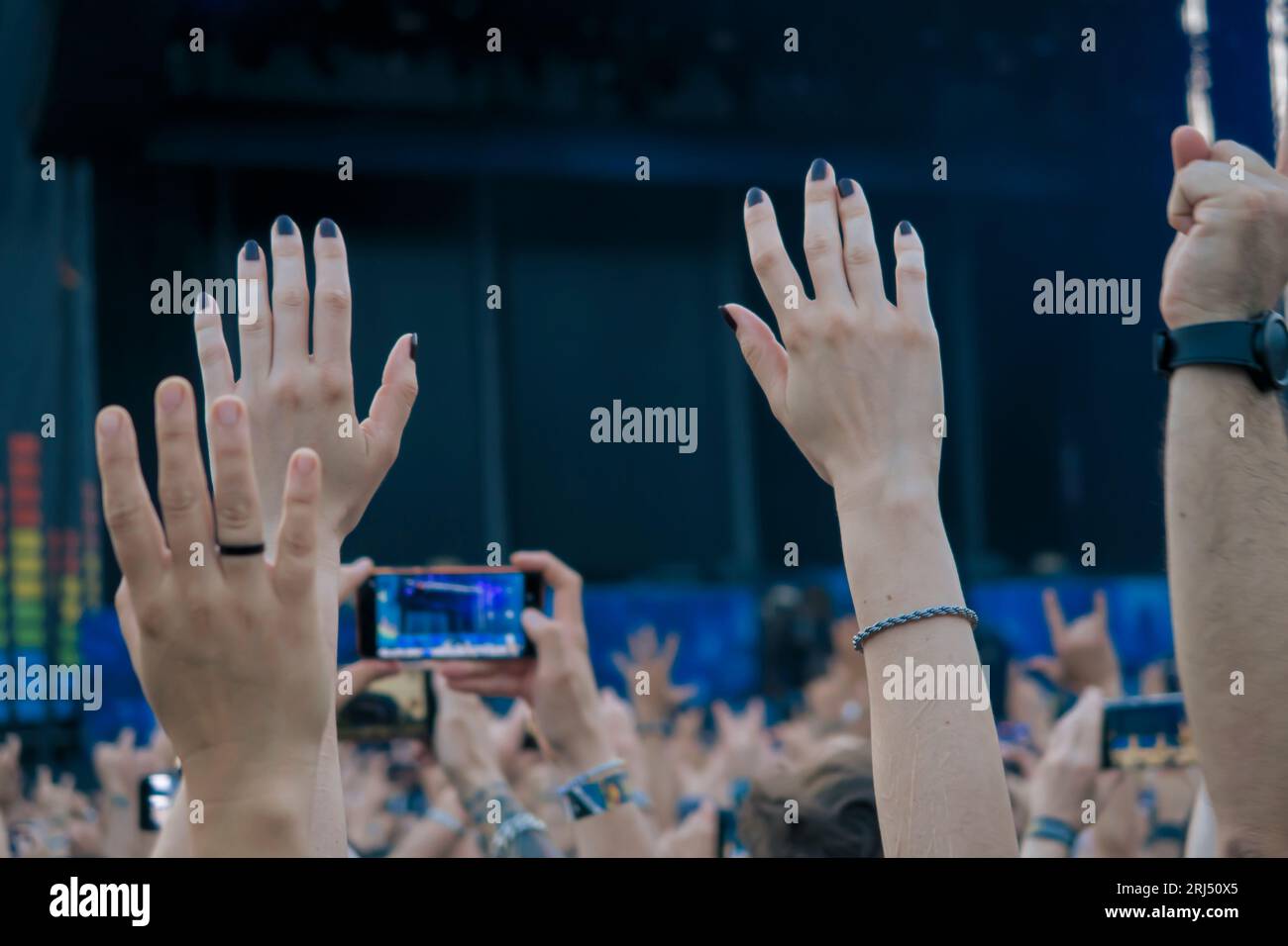 Detail of people raising hands in front of a music stage Stock Photo ...