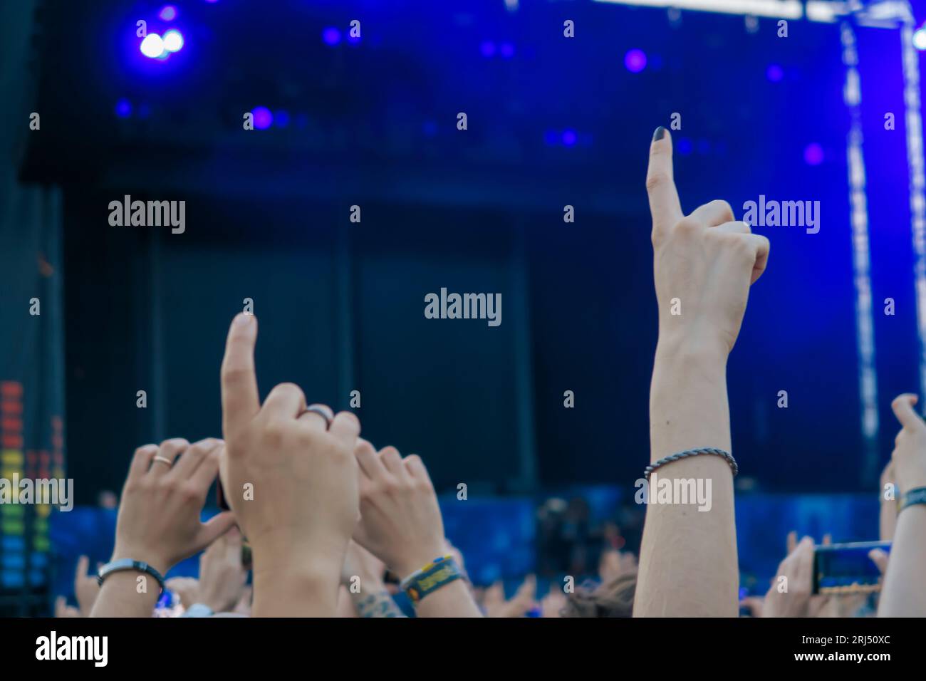 Detail of people raising hands in front of a music stage Stock Photo ...