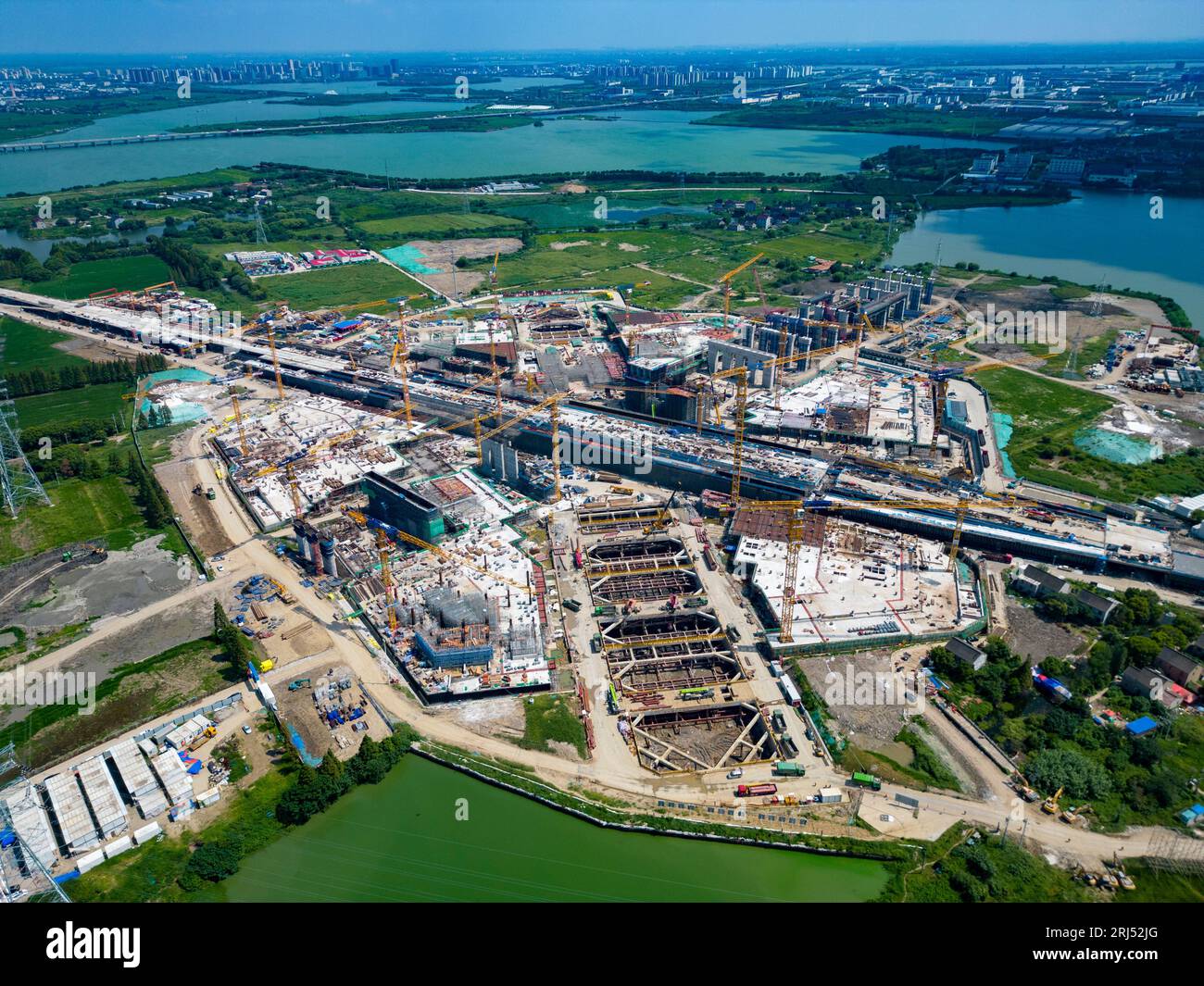 SUZHOU, CHINA - AUGUST 19, 2023 - Tower cranes stand at the ...