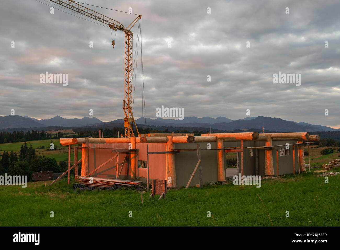 Construction site of a new log house in the mountains Stock Photo - Alamy