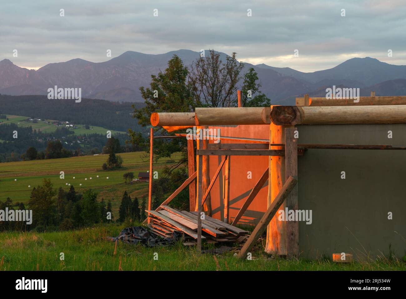 Construction site of a new log house in the mountains Stock Photo - Alamy