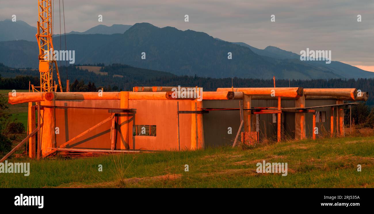Construction site of a new log house in the mountains Stock Photo - Alamy