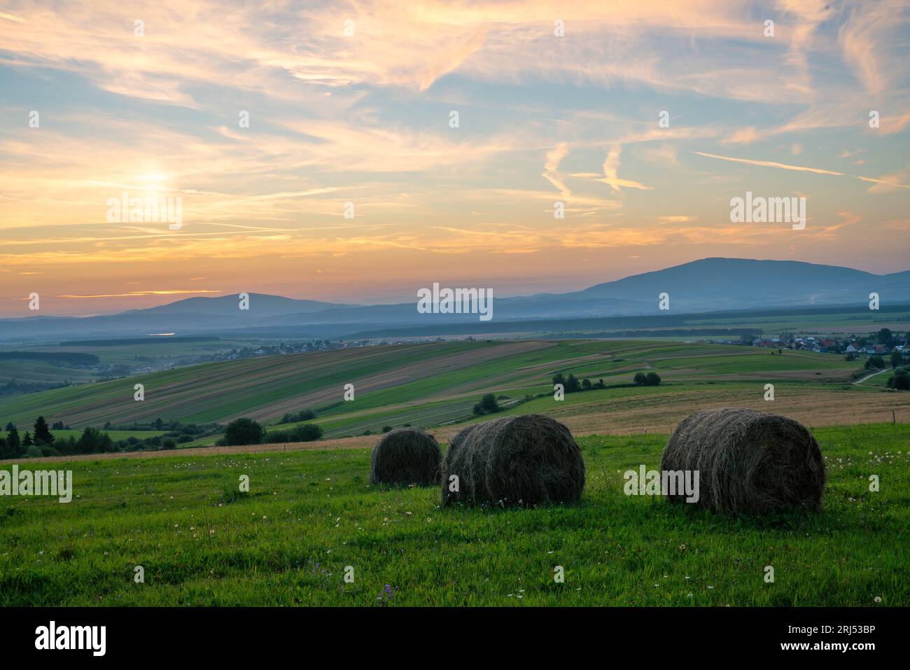 Green field haystacks hi-res stock photography and images - Alamy