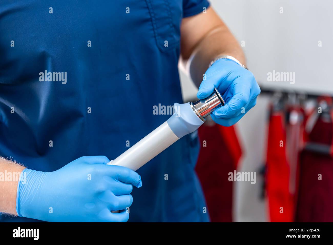Shock wave therapy device with male doctor hands in rubber gloves Stock ...