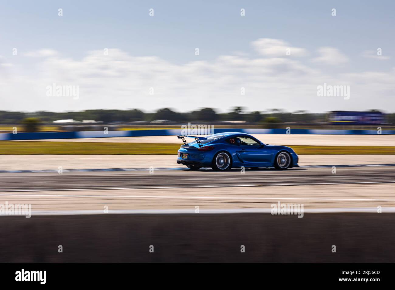 A Porsche Cayman car driving around a winding track Stock Photo - Alamy