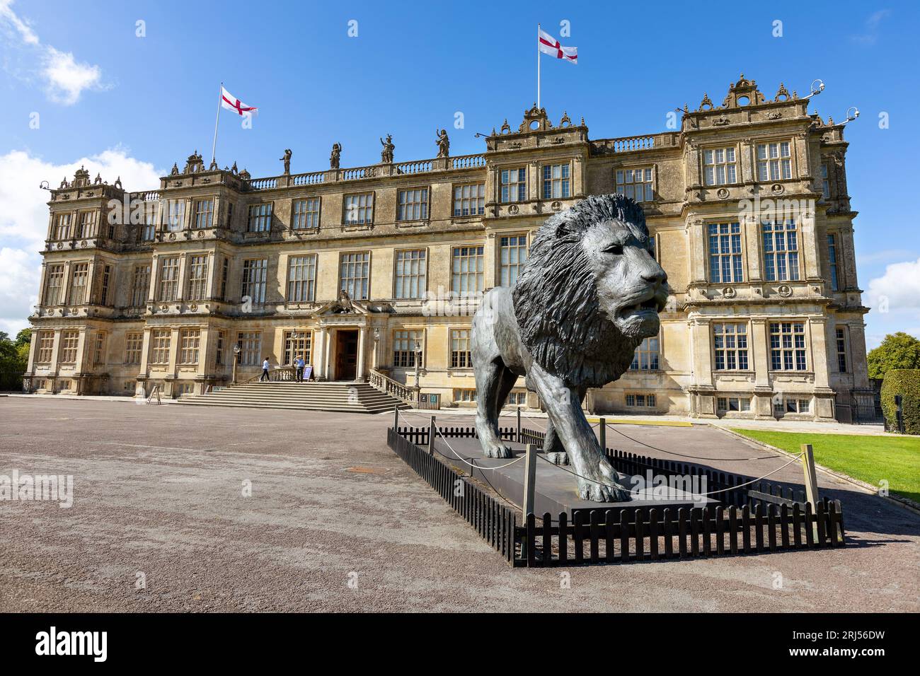 The imposing facade of Longleat House with a statue of one of the ...