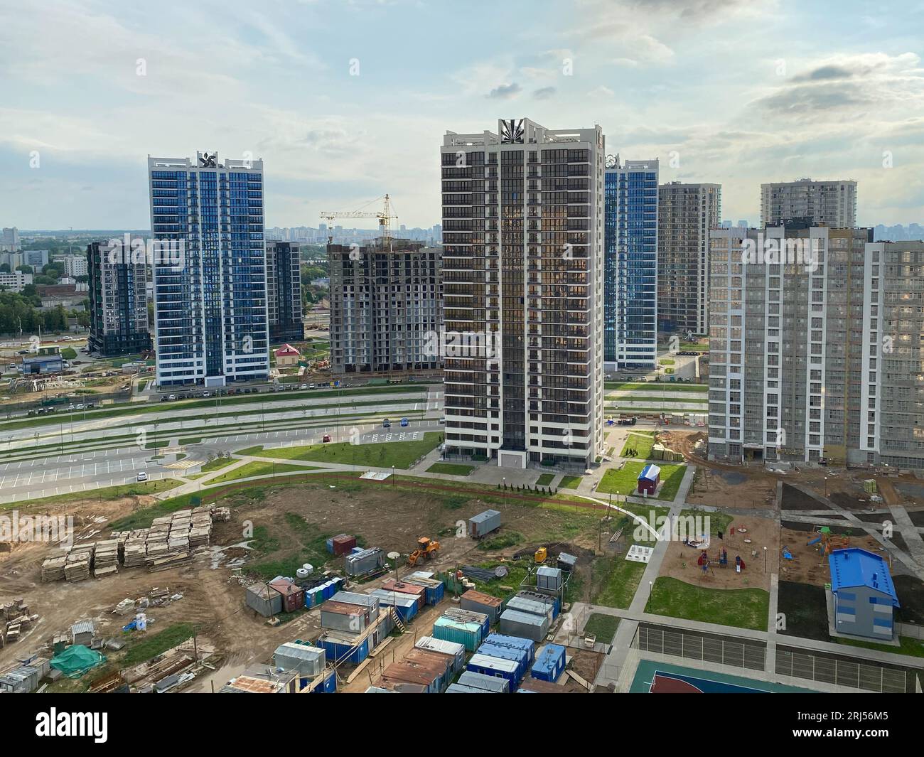 A view from a height of a large modern construction site of tall large ...