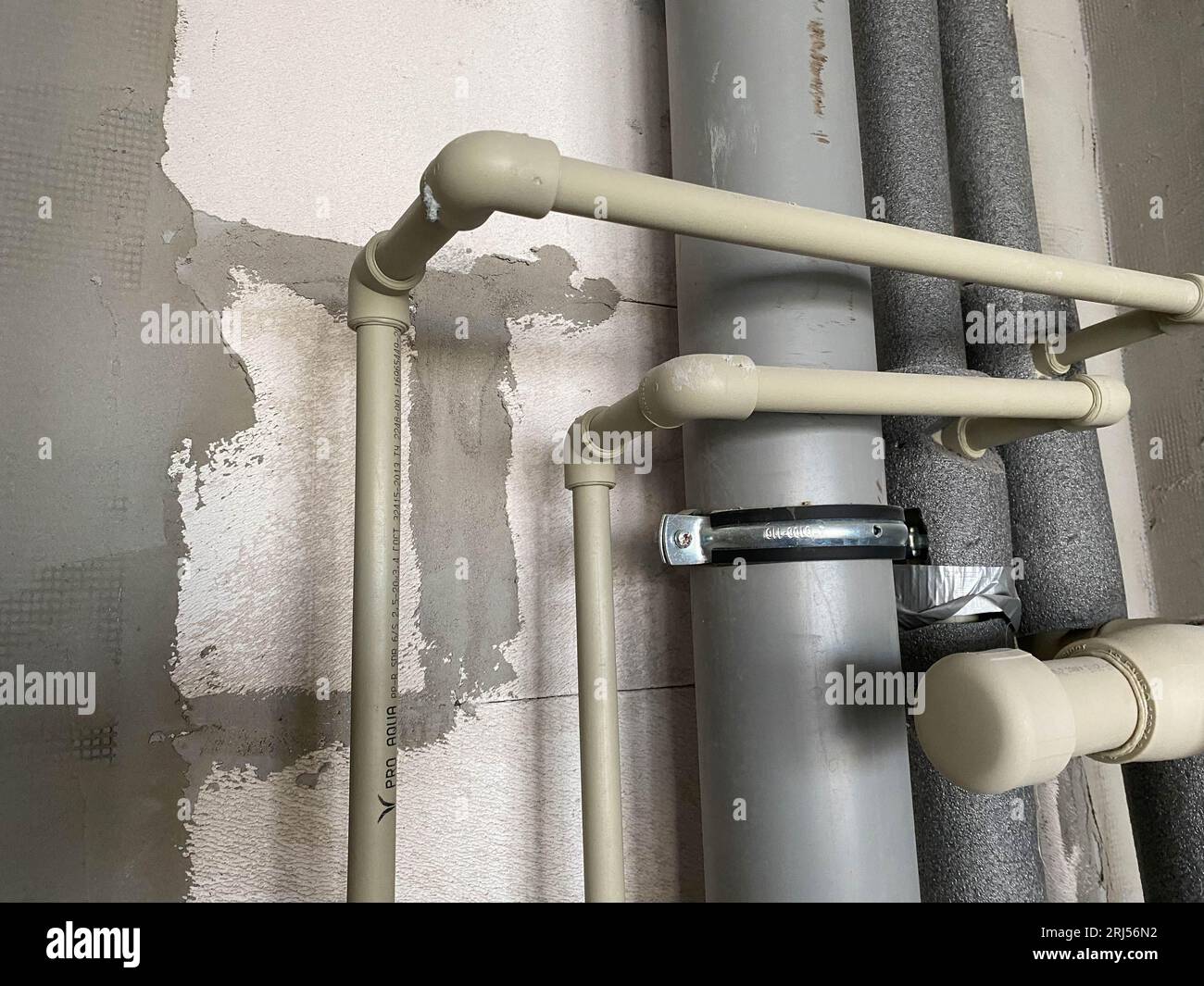 New plastic pipes and colorful equipment in industrial boiler room ...