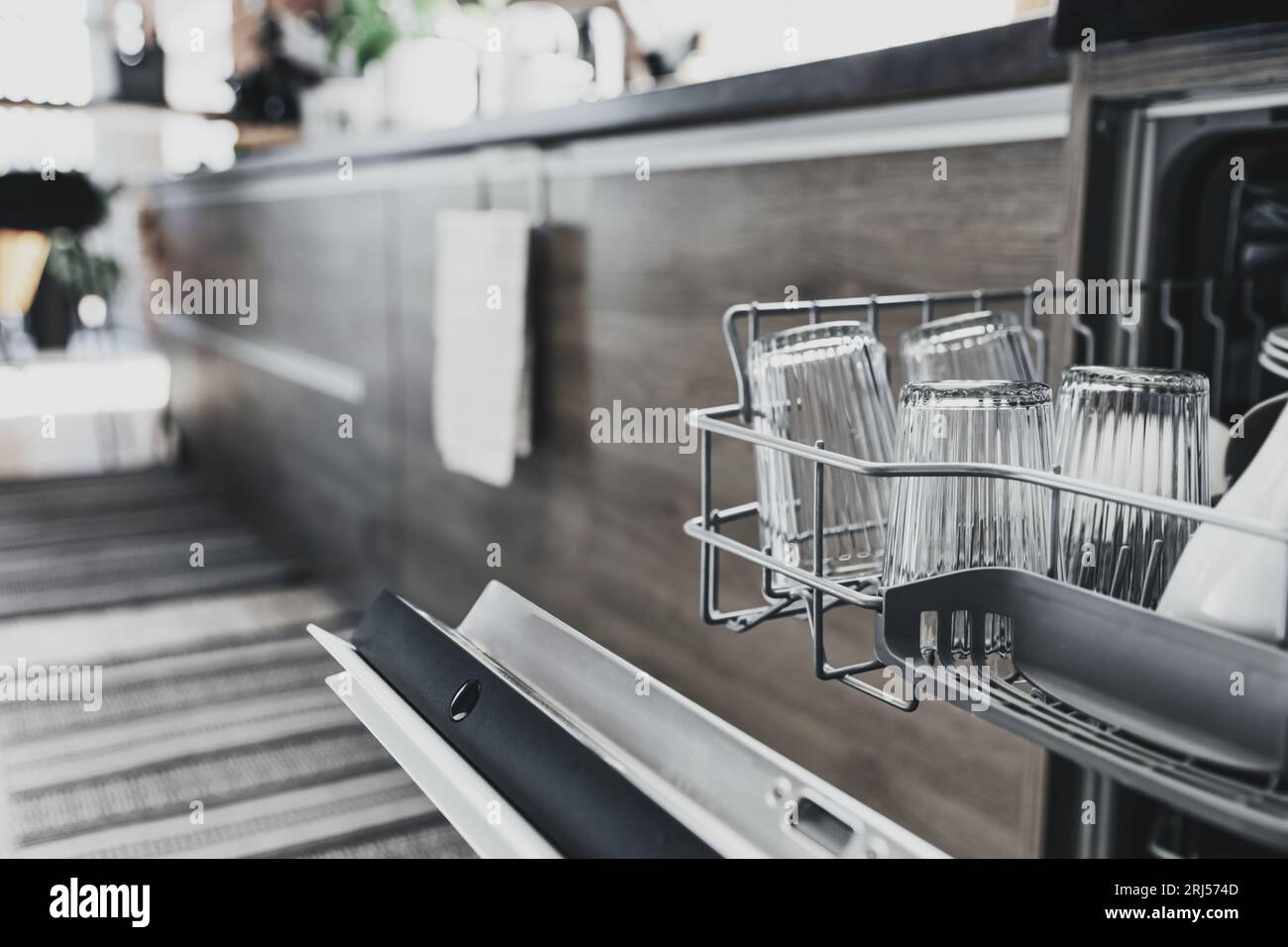 Closeup of opened automatic stainless built-in dishwasher machine ...