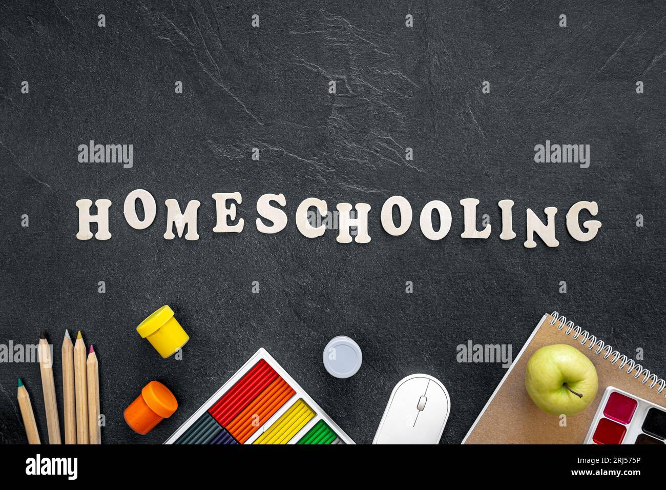 Homeschooling word made of wooden letters on a black background, top ...