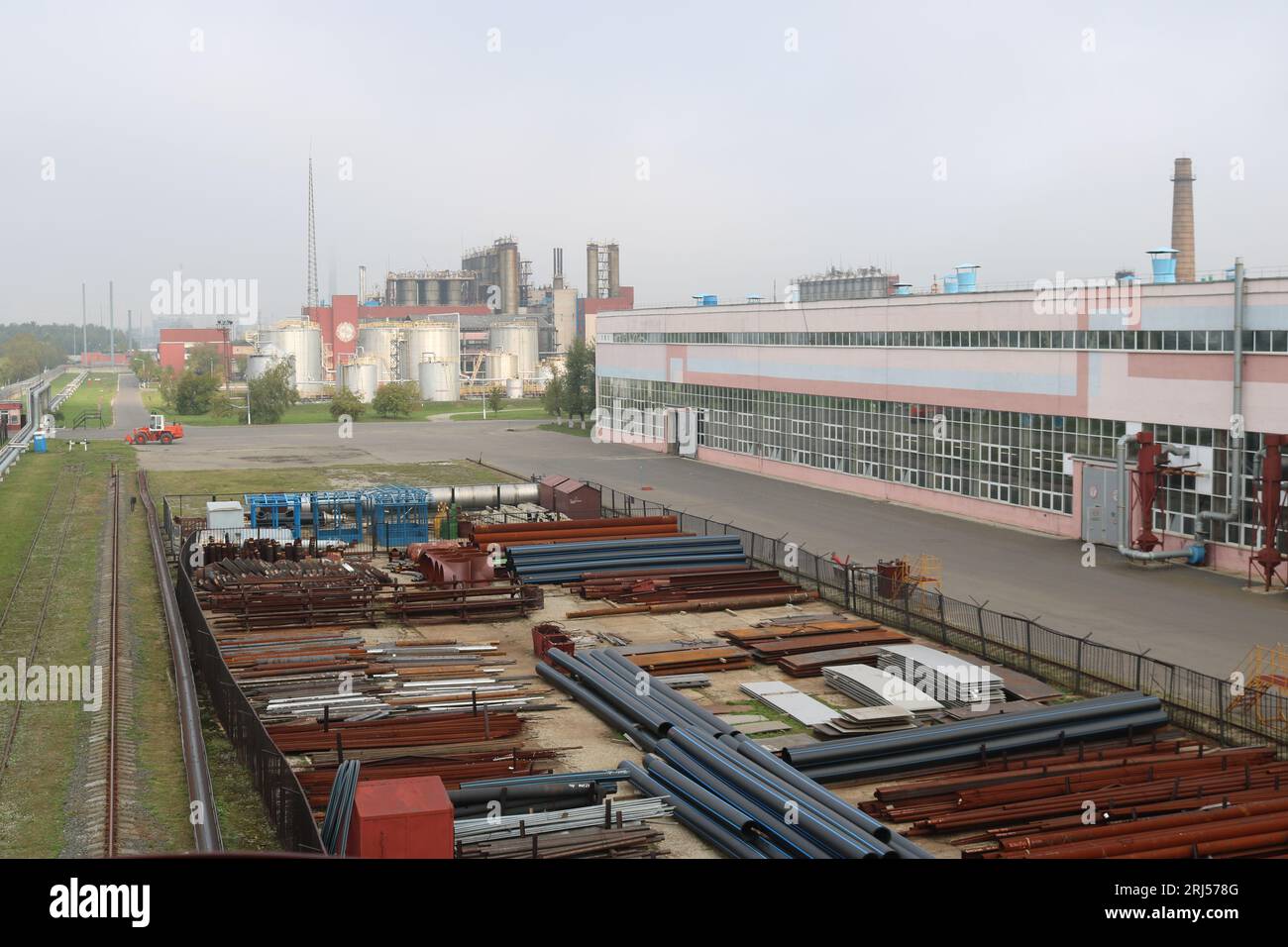 Large industrial warehouse in the open air for storing iron metal pipes ...