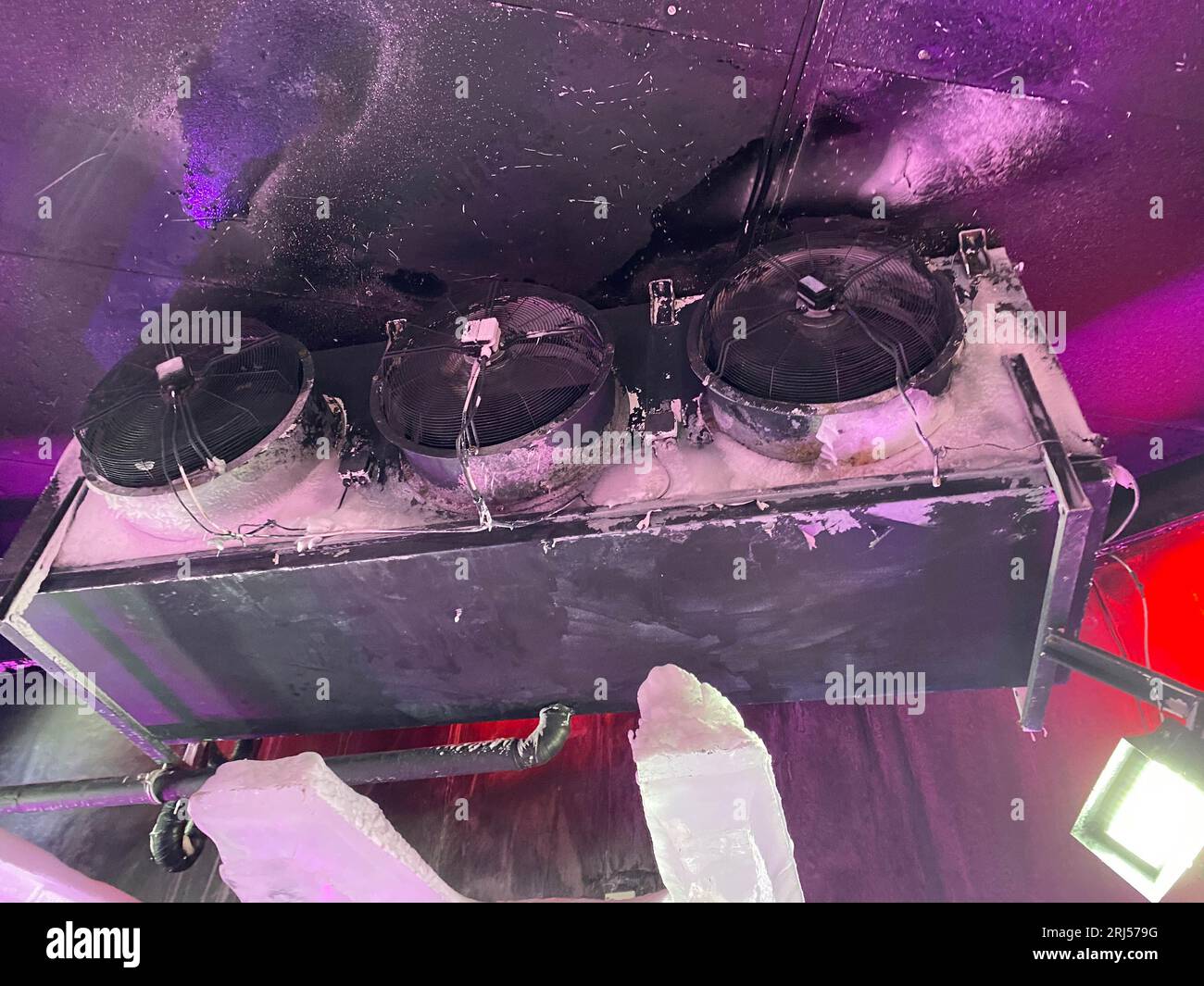 Two large and one small air conditioner covered with snow from above ...