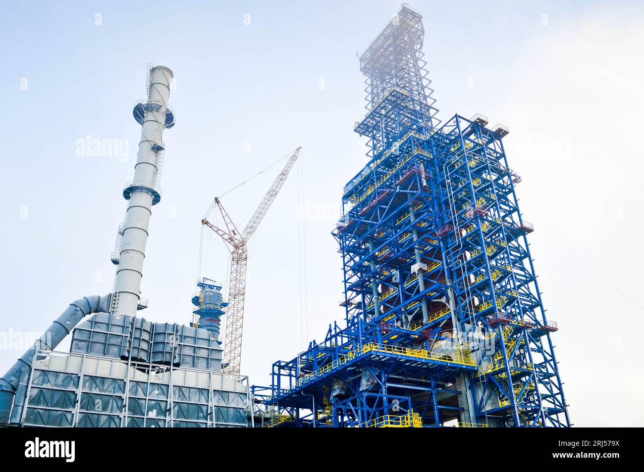Construction with cranes of a large blue chemical plant at an oil ...
