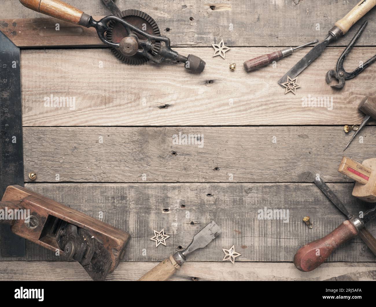 Vintage carpenter tools as a frame on a rustic wooden workbench with ...