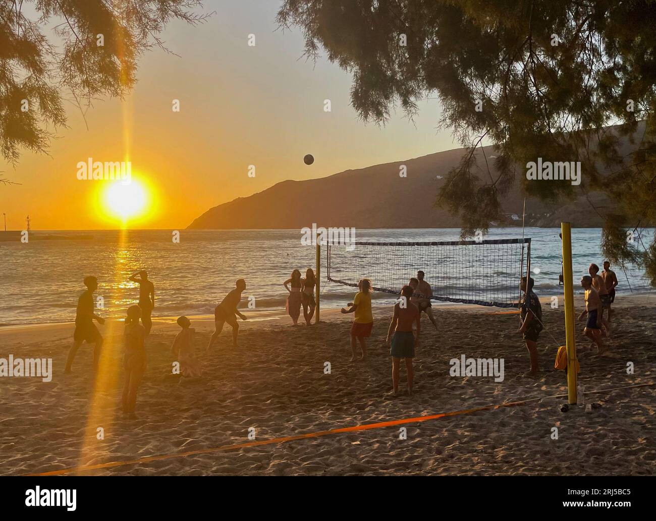 A game of Volleyball on a beach in Aiyiali, Amorgos. As the sun sets ...