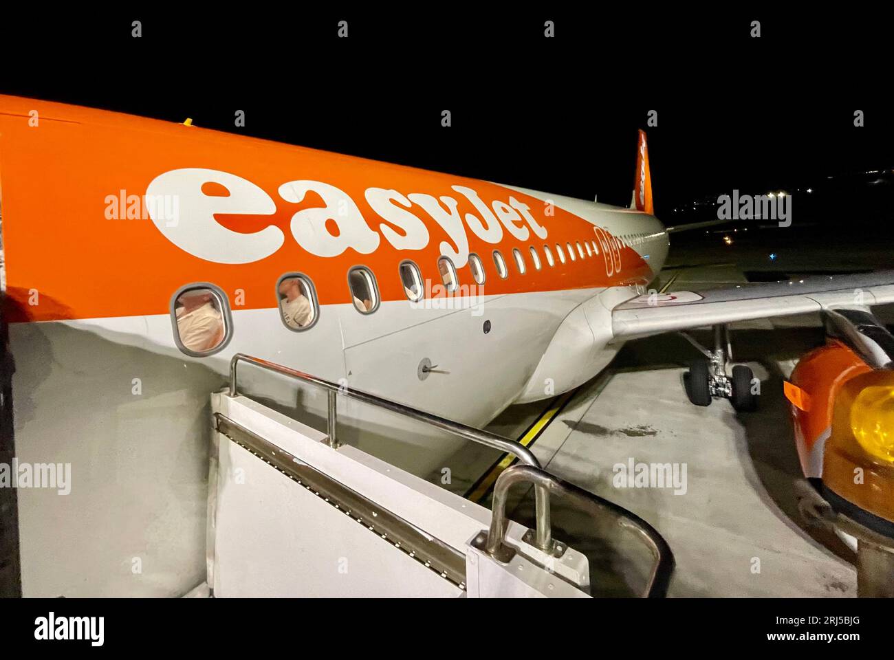 Passengers board an Easyjet Airbus 320 at Mykonos Airport in Greece ...