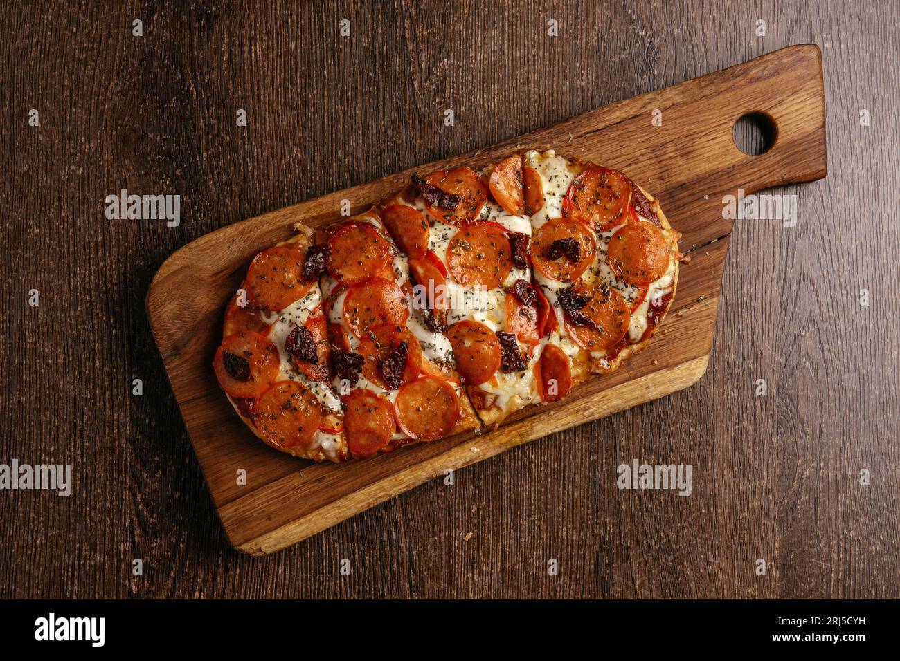 italian pizzetta with sausage on a wooden board. Restaurant menu Stock ...