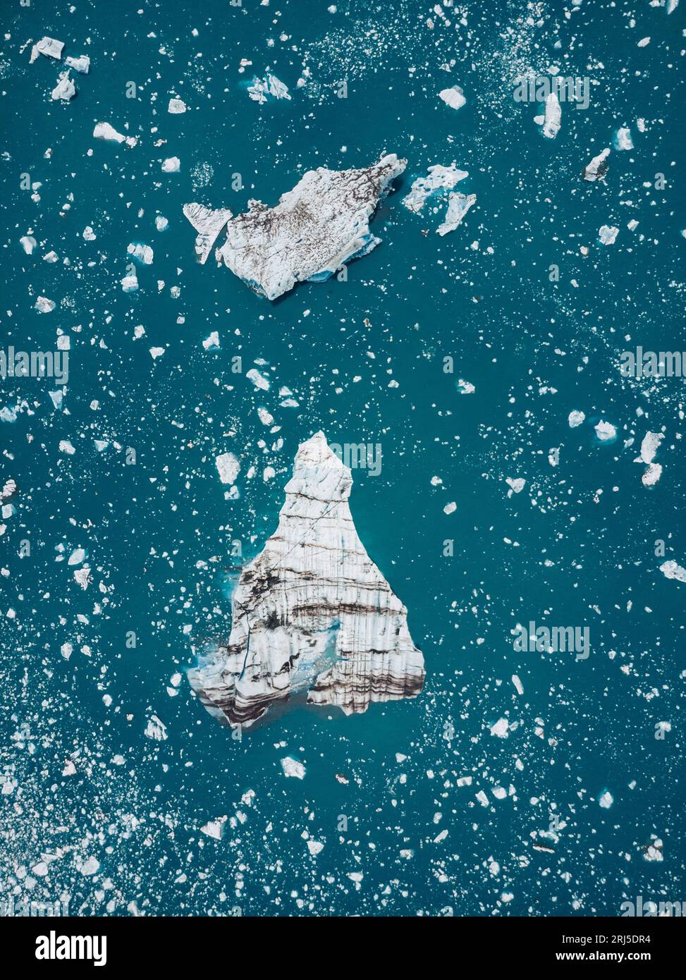 A scenic view featuring icebergs floating in the tranquil waters of a ...