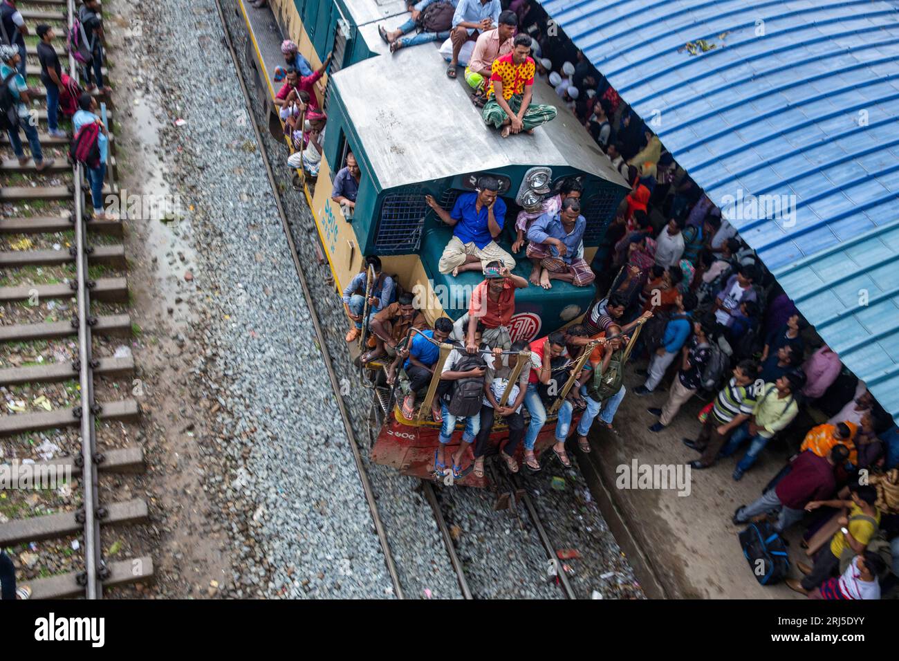 An overcrowded train leaves the Airport Railway Station in Dhaka ahead ...