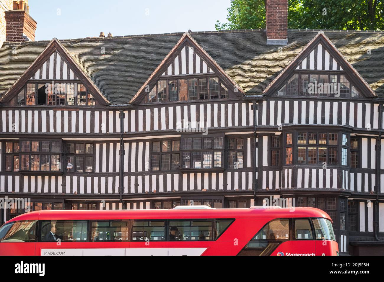 An Iconic London bus passing a Tudor building, Staple Inn on the south ...