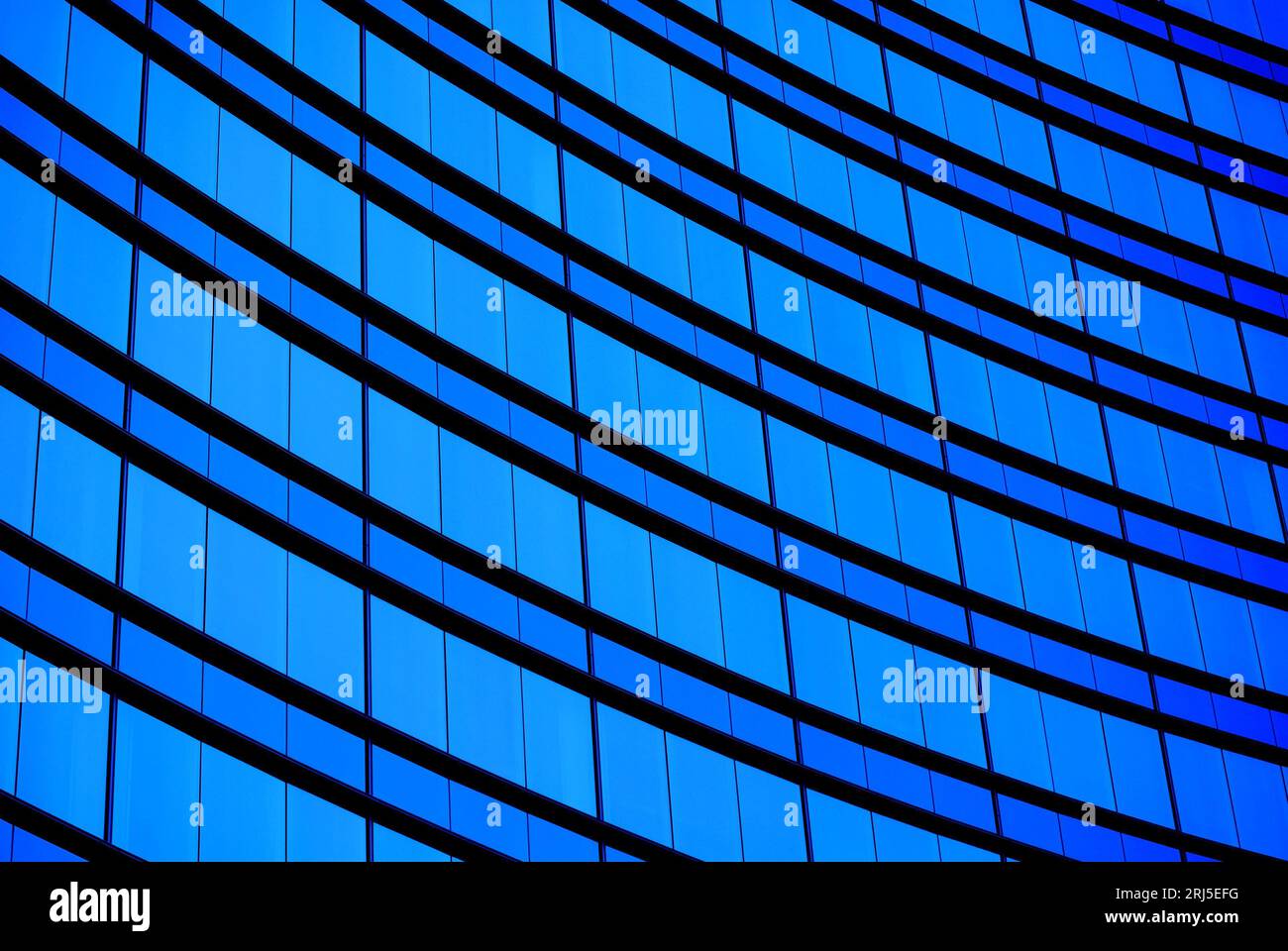 A close-up of a modern architectural building with blue windows Stock ...