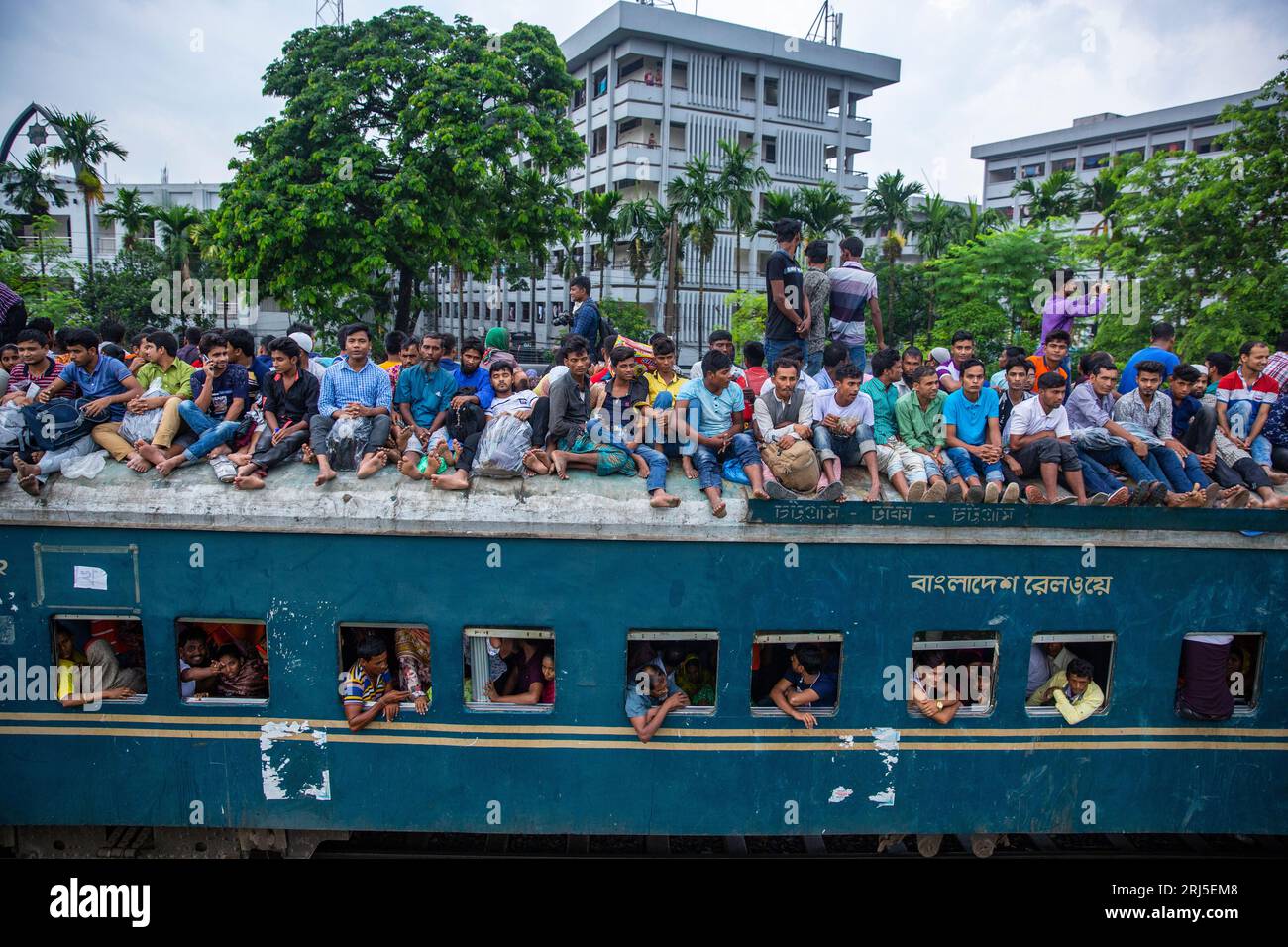 An overcrowded train leaves the Airport Railway Station in Dhaka ahead ...